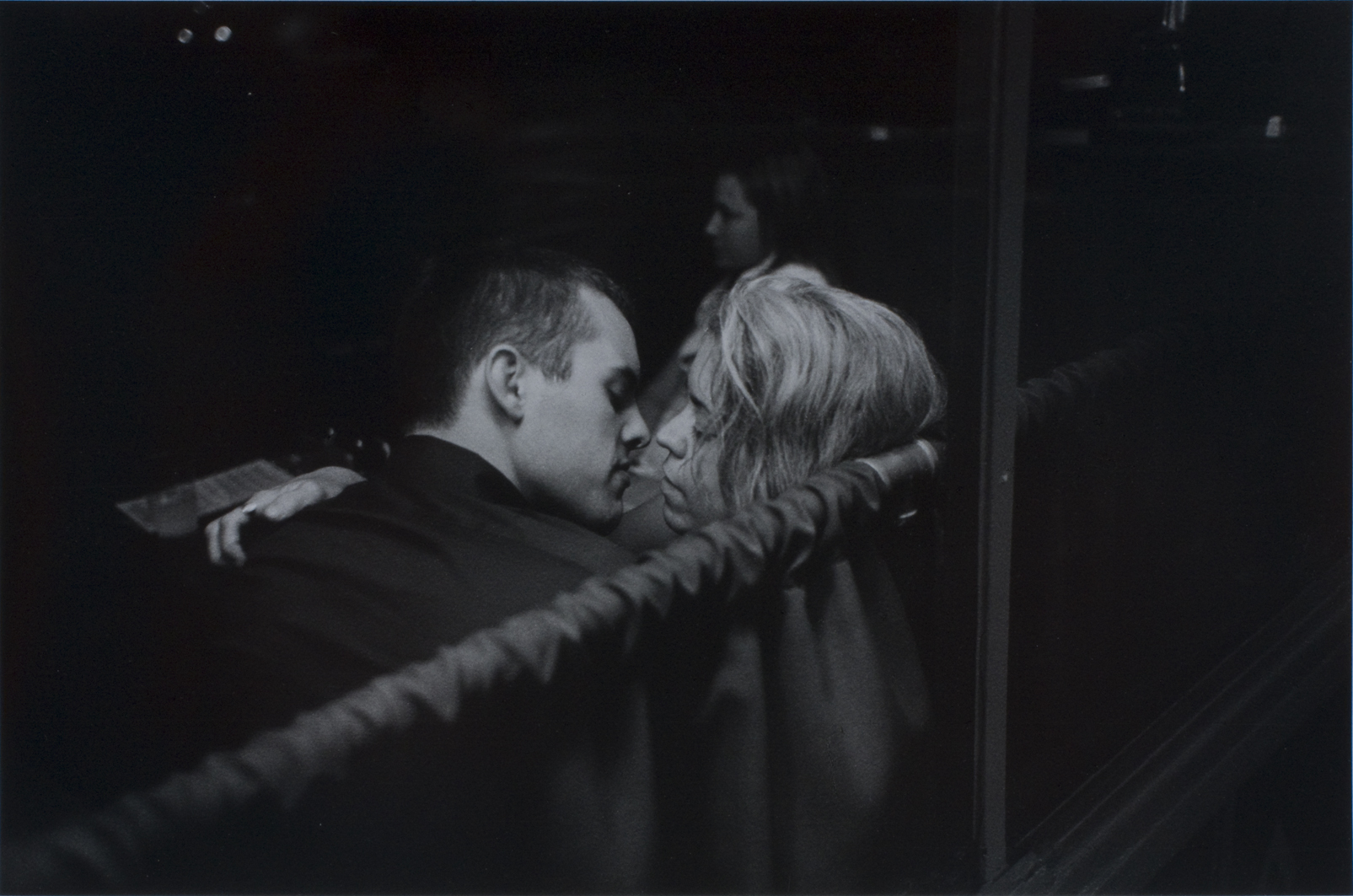 Couple Kissing Through Window at Ringlers in Portland, OR